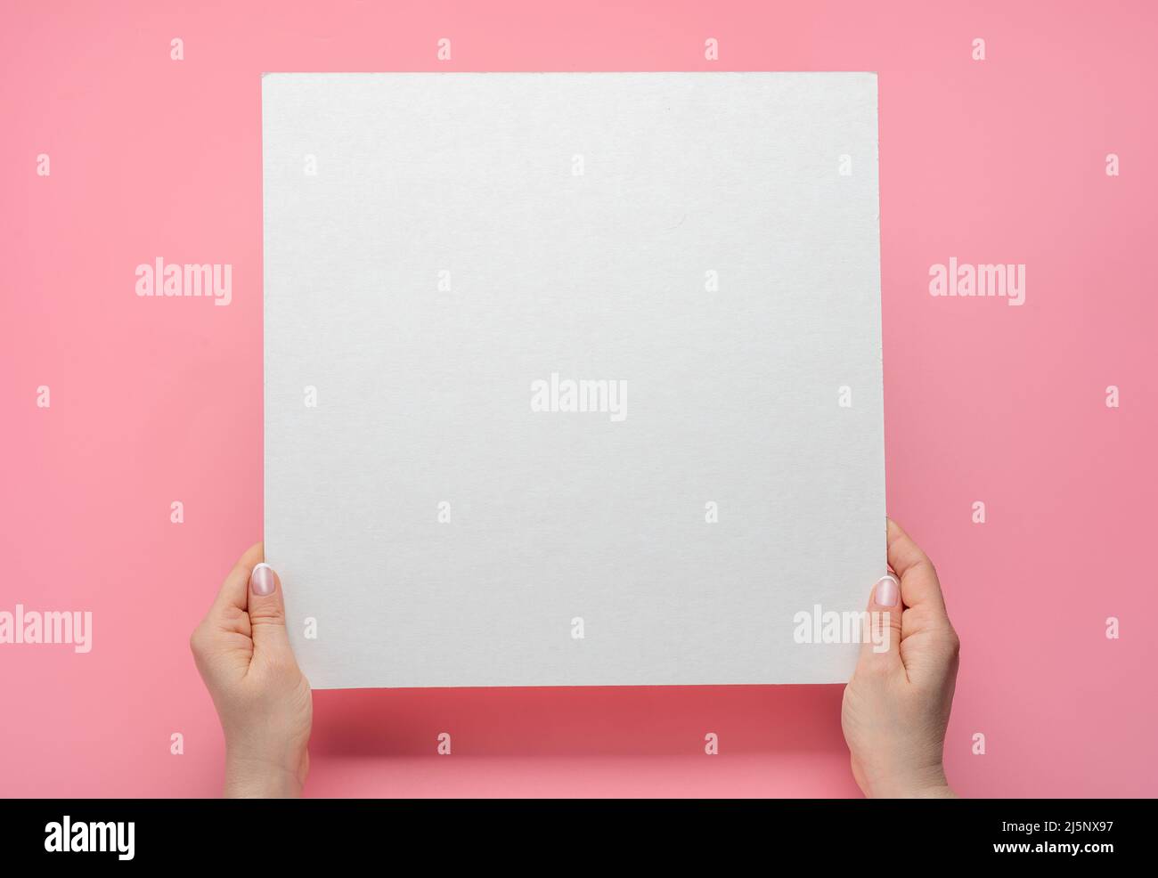 Mockup square paper. Overhead shot of woman hands with blank paper ...