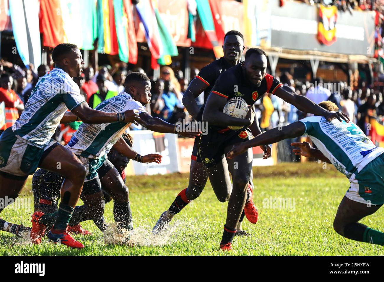 Kampala, Uganda. 24th Apr, 2022. Ian Munyani (2nd R) of Uganda breaks ...