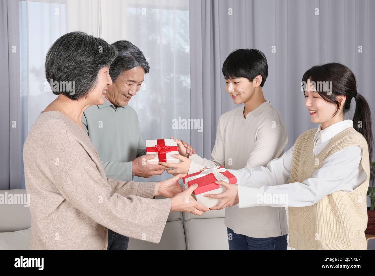 Asian Korean family giving gift Stock Photo - Alamy