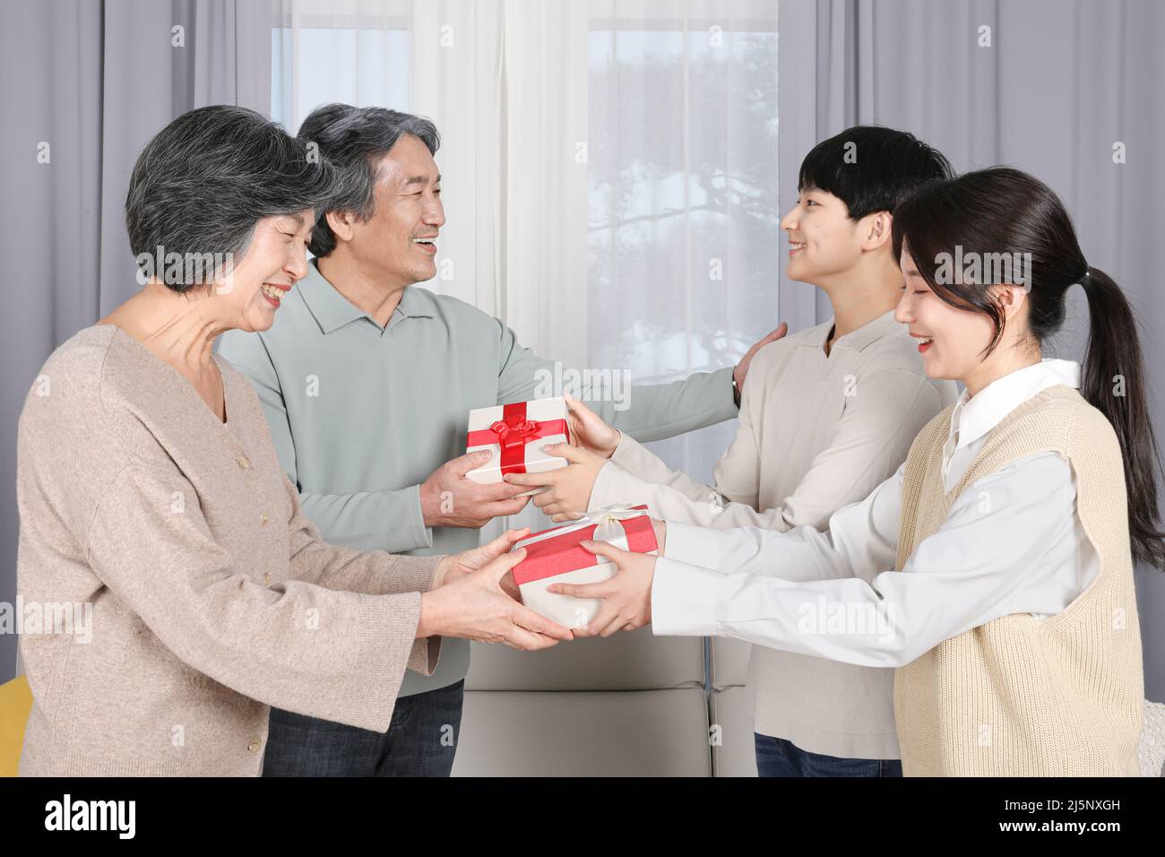 Asian Korean family giving gift Stock Photo - Alamy