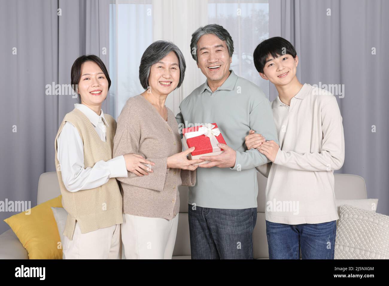 Asian Korean family giving gift Stock Photo - Alamy