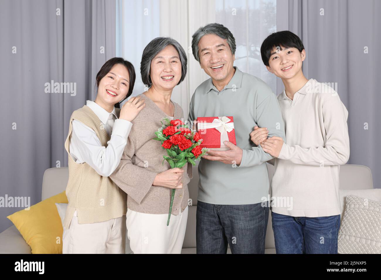 Asian Korean Family giving gift Boxes and Flowers Stock Photo - Alamy