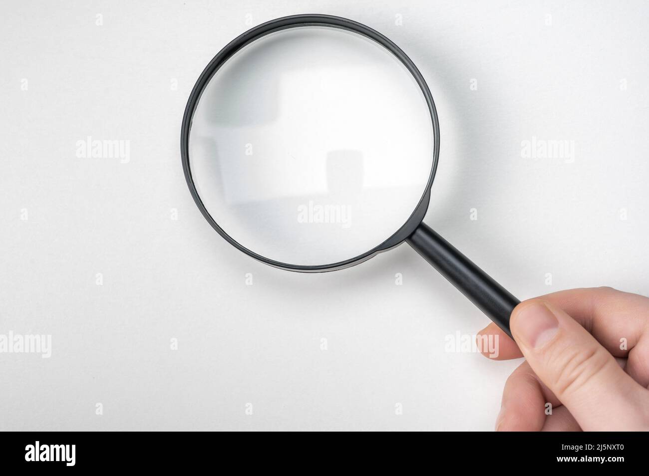 Hand holding magnifying glass isolated on white background. man hand ...