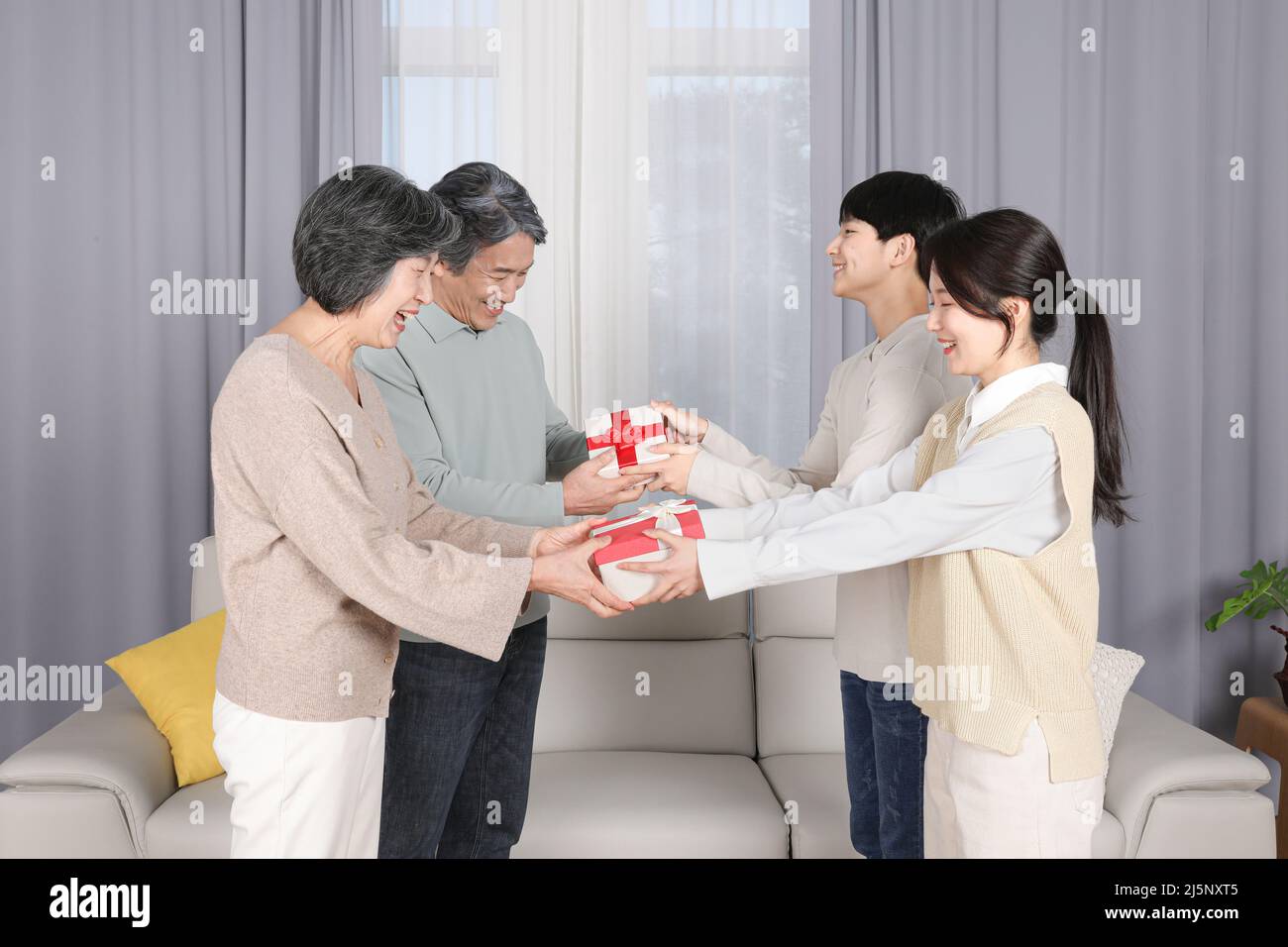 Asian Korean family giving gift Stock Photo - Alamy