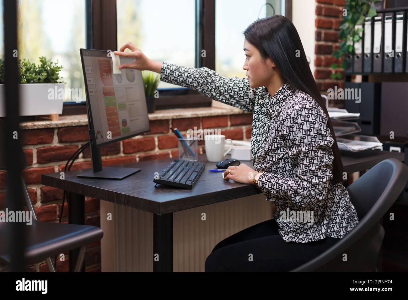 Marketing company recruiter sticking potential customer contact note on ...