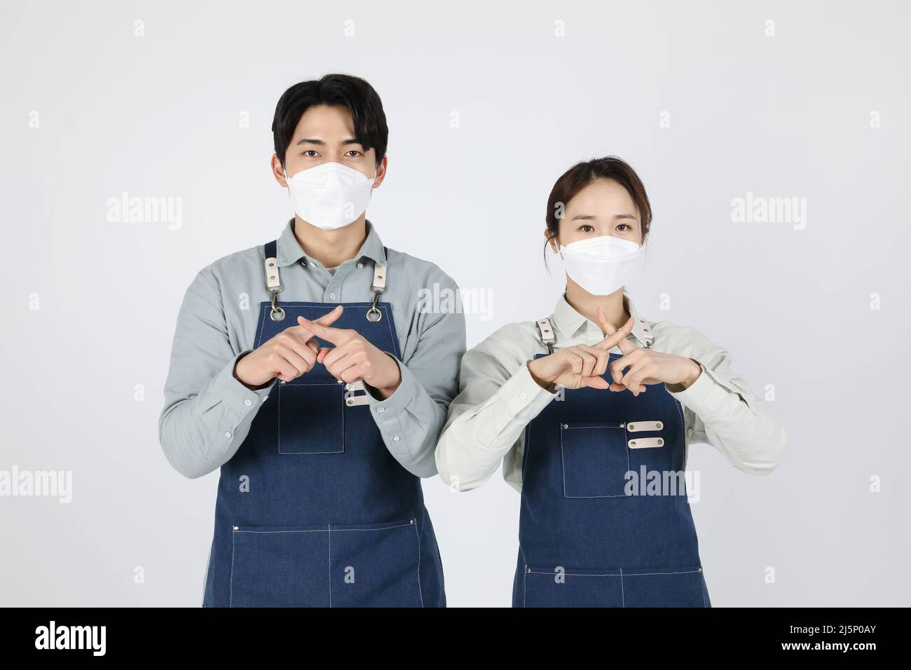 Asian Korean young man and woman startup concept doing X-shaped hand ...