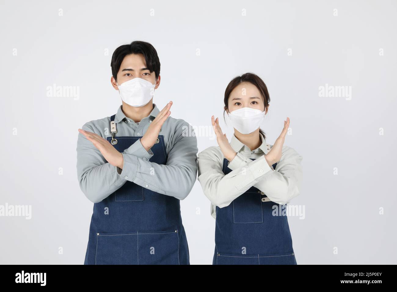 Asian Korean young man and woman startup concept doing X-shaped hand ...