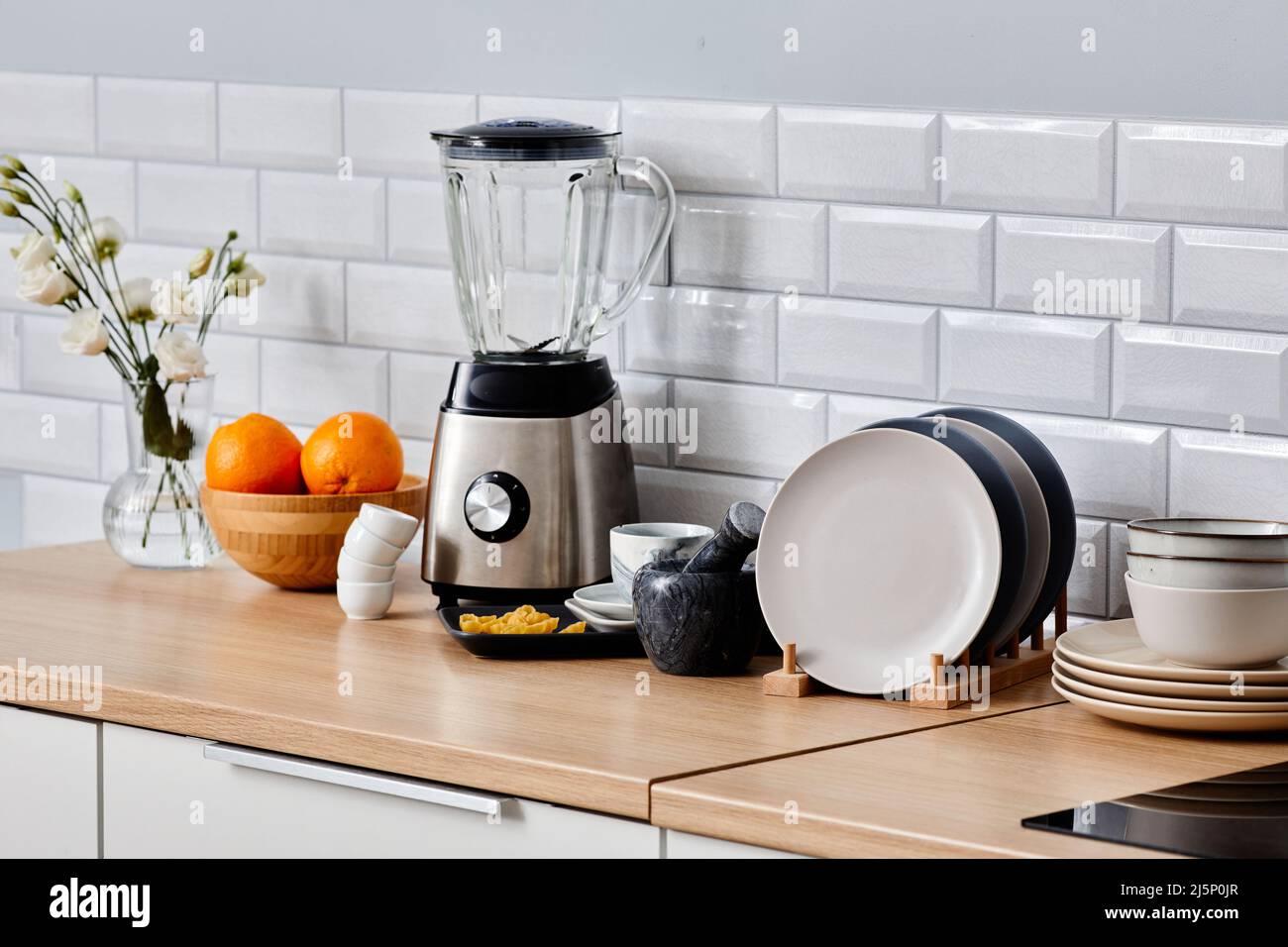 Image of electric blender, set of ceramic plates and other kitchen ...