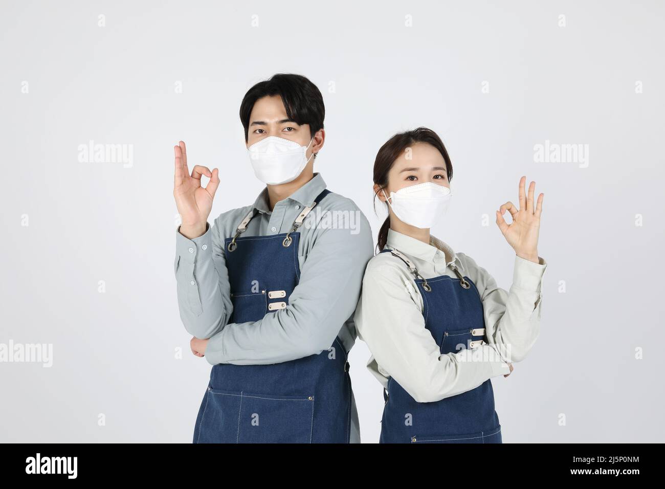 Asian Korean young man and woman startup concept Okay doing hand ...