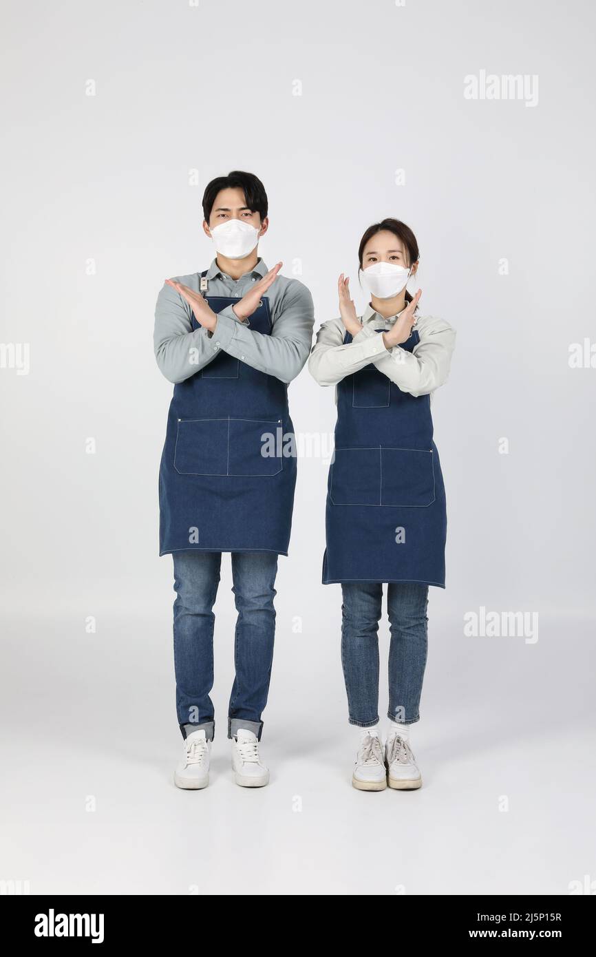 Asian Korean young man and woman startup concept doing X-shaped hand ...