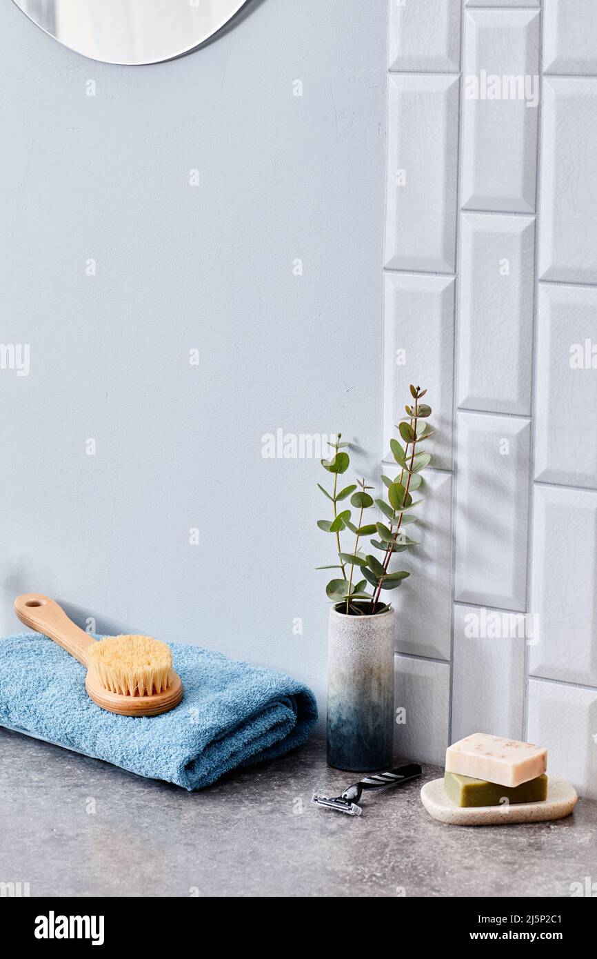 Vertical image of table in bathroom with hygiene products, towel and ...