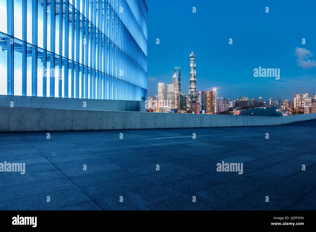 Empty square floor and city skyline with buildings in Shanghai at night ...