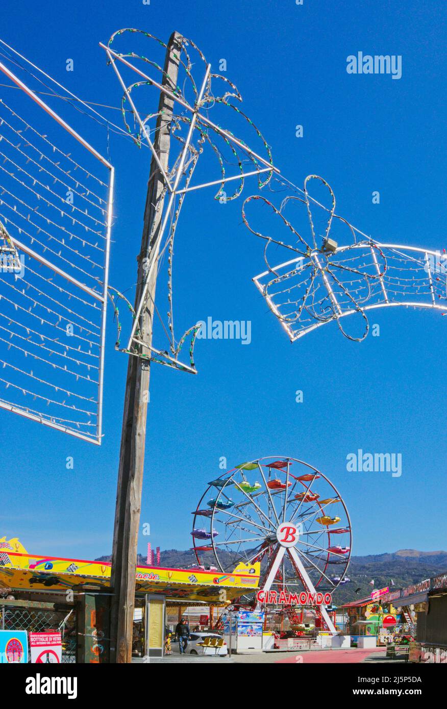 fun fair entrance and ferris wheel in the background Stock Photo - Alamy