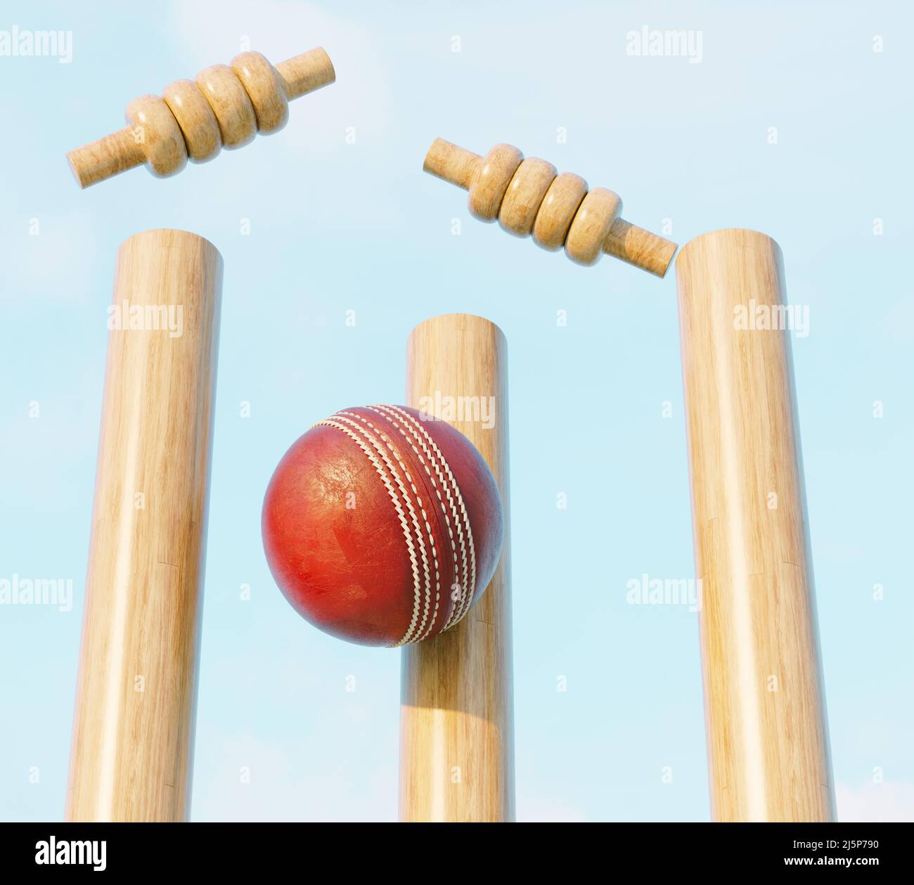 Wooden cricket wickets with dislodging bails on a day sky background ...