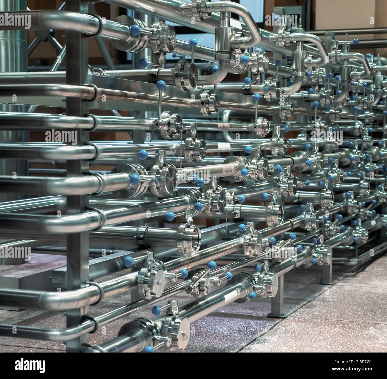 System of steel pipes in food and drink processing plant. Pipelines in ...