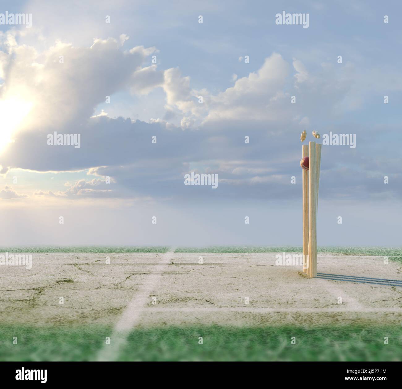 Wooden cricket wickets with dislodging bails on a day sky background ...