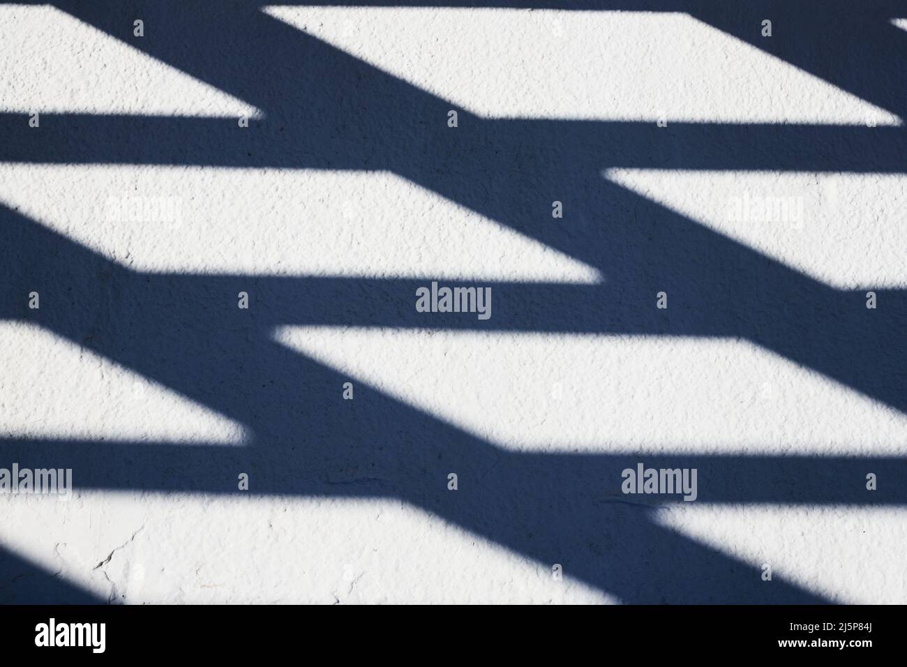 Geometric shadows on the wall. Bright sunny day. Texture of the wall ...