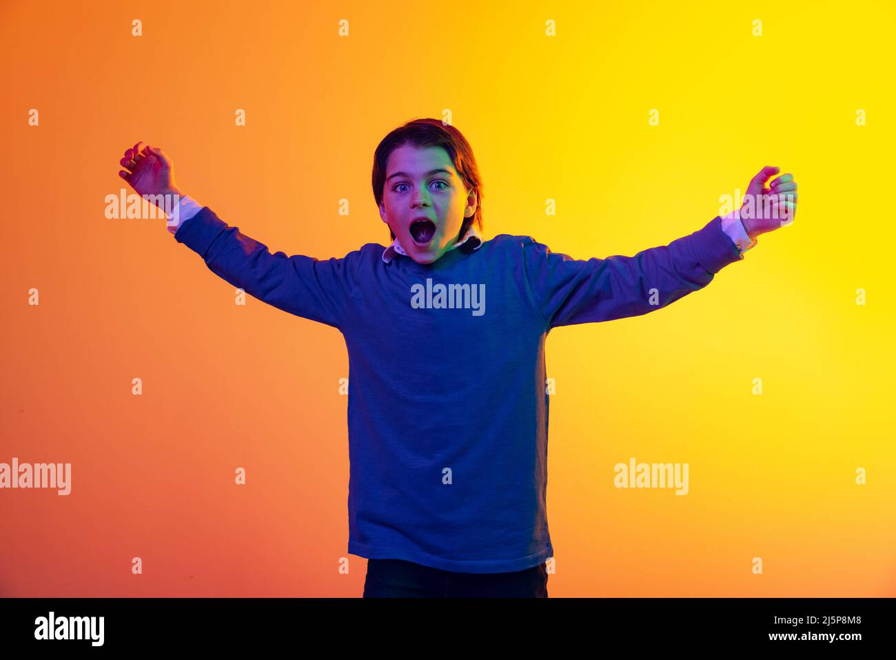 Portrait of cute boy, child showing emotion of excitement, spreading ...