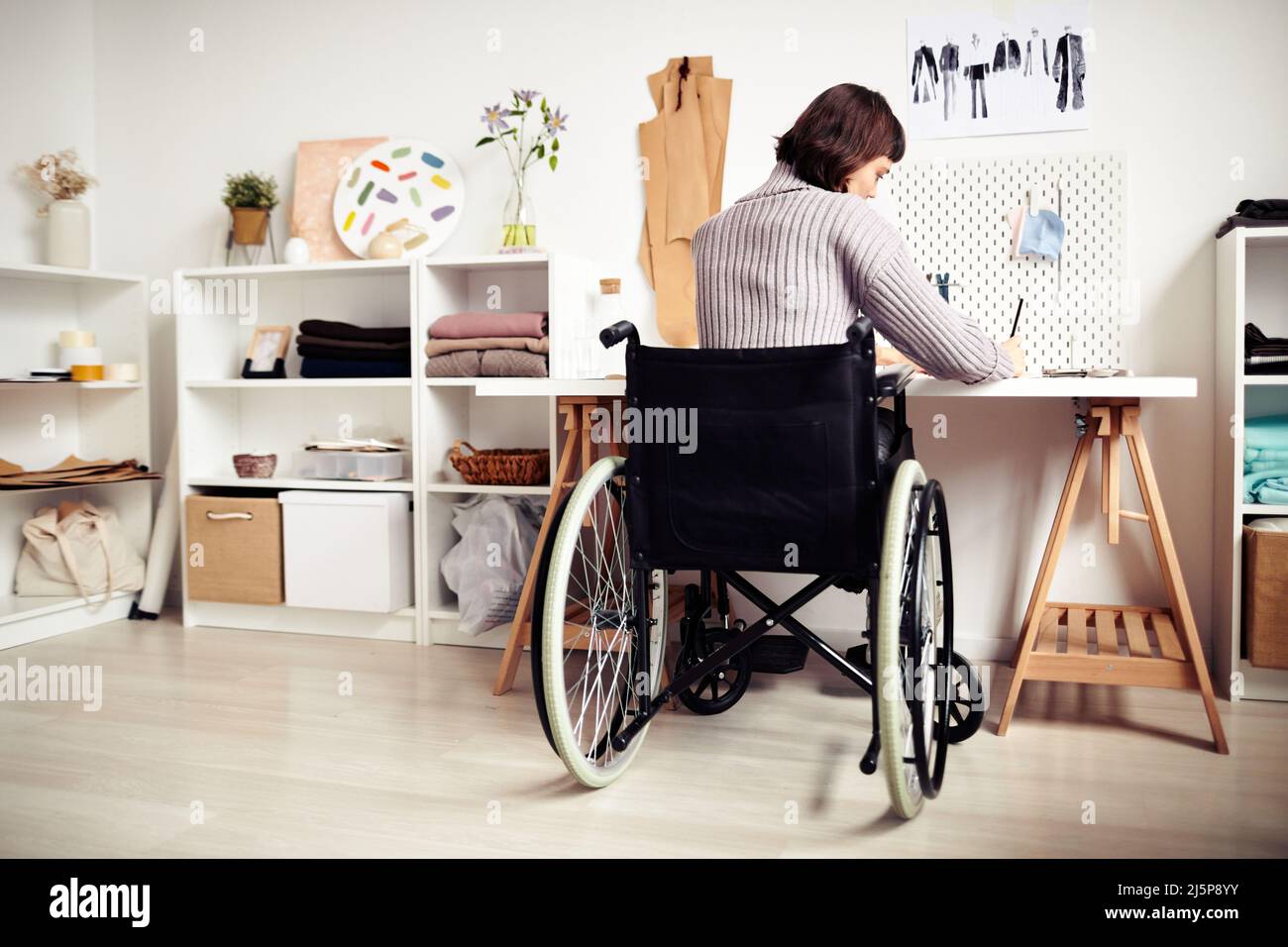 Talented creative young woman with disability drawing fashion sketches ...