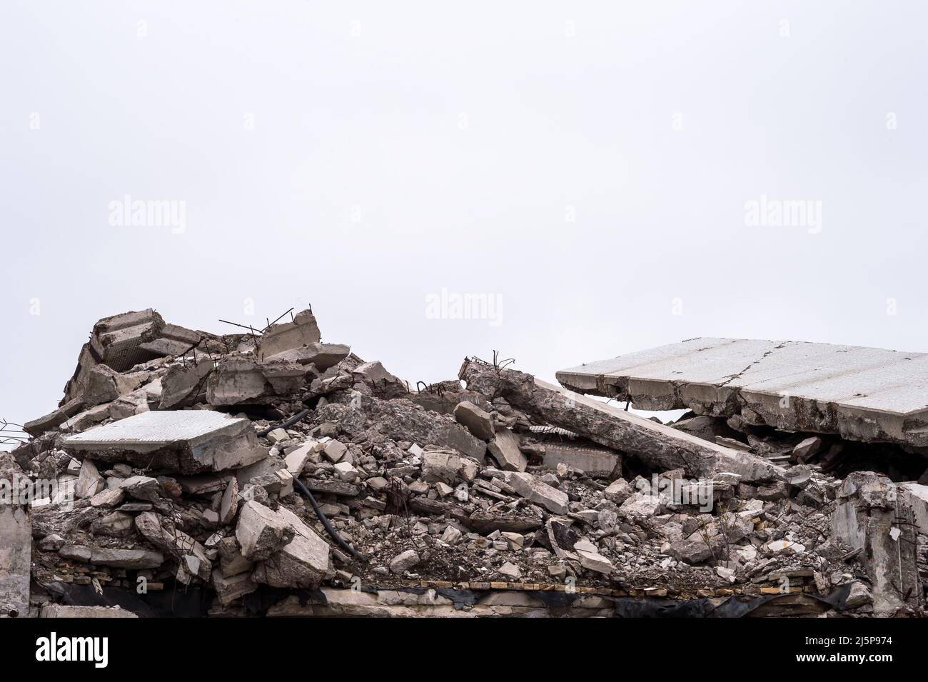 The remains of a destroyed building in the form of a pile of gray ...
