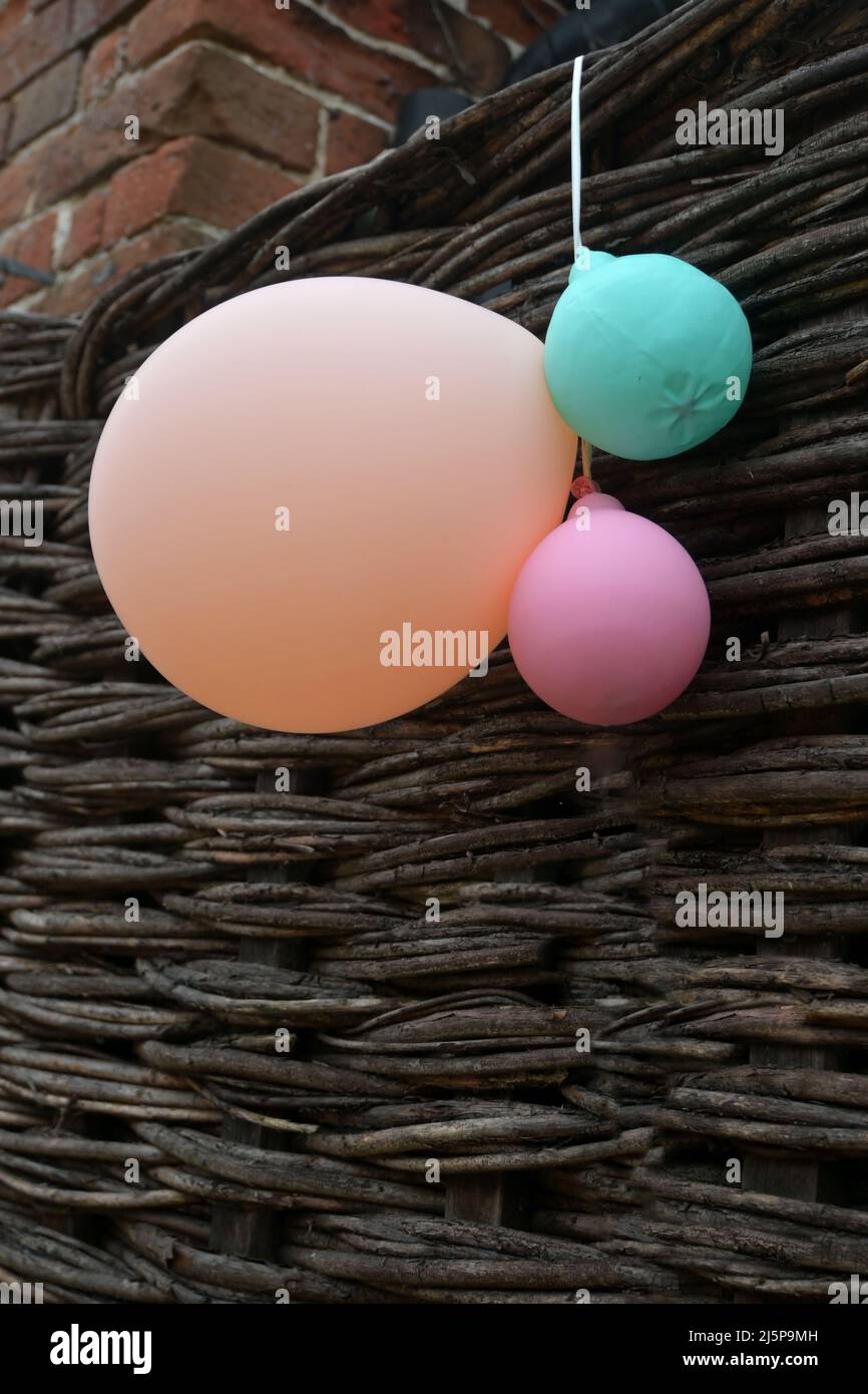 three balloons on fence Stock Photo - Alamy
