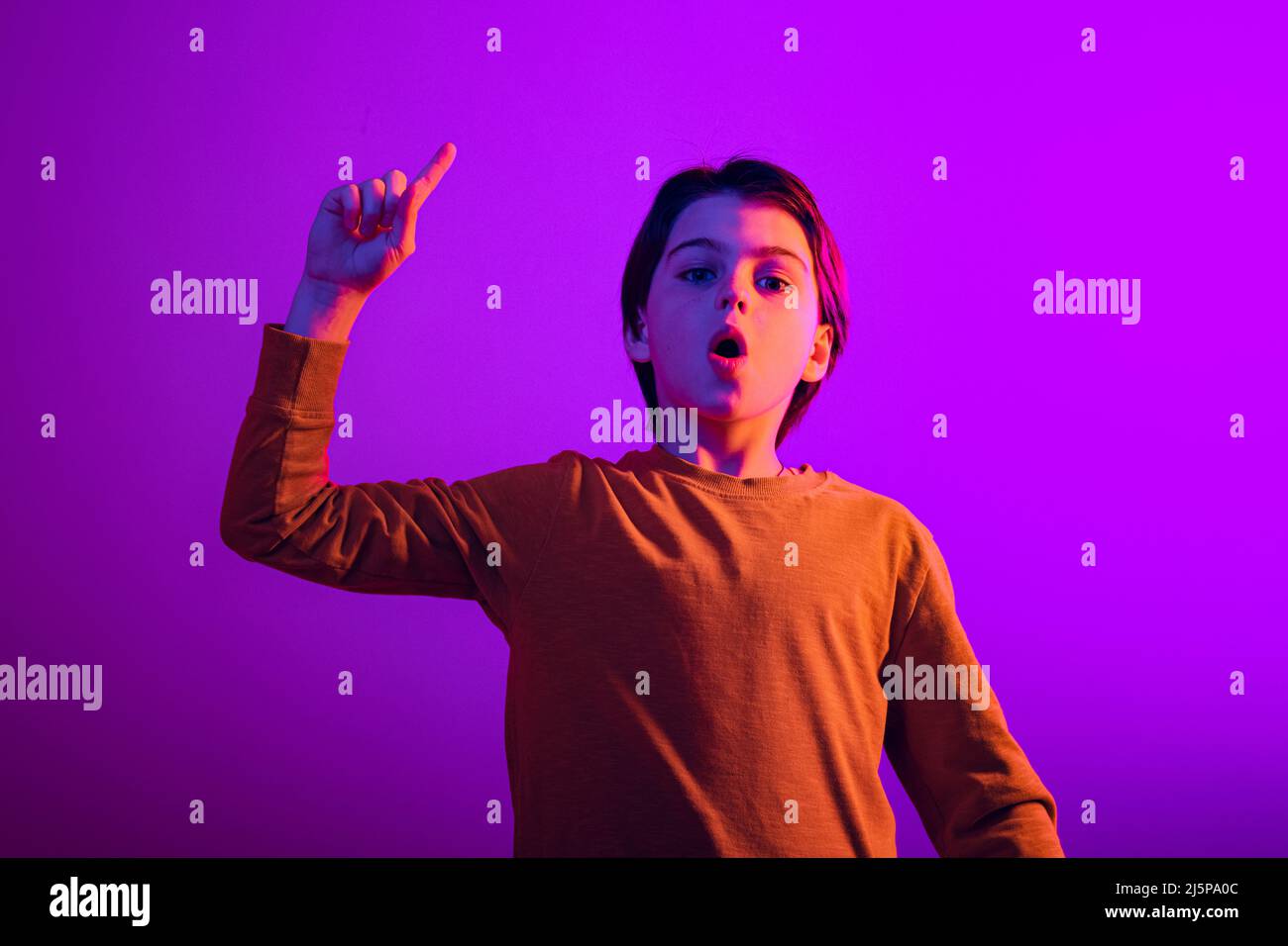 Portrait of boy, child rising finger, having new idea isolated over ...