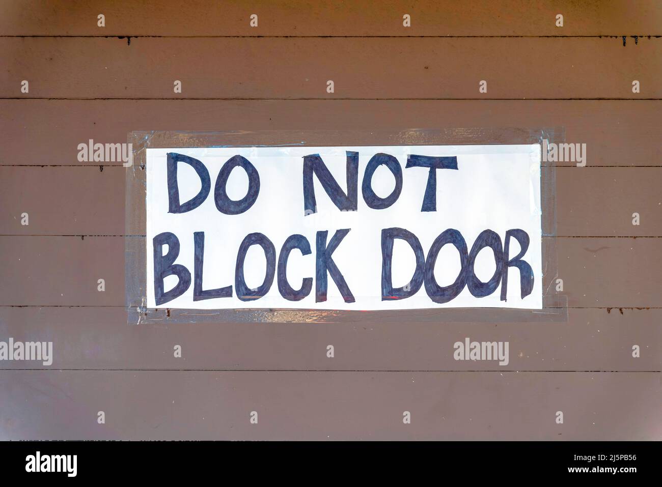 Do not block door signage on a brown wooden wall at San Francisco ...