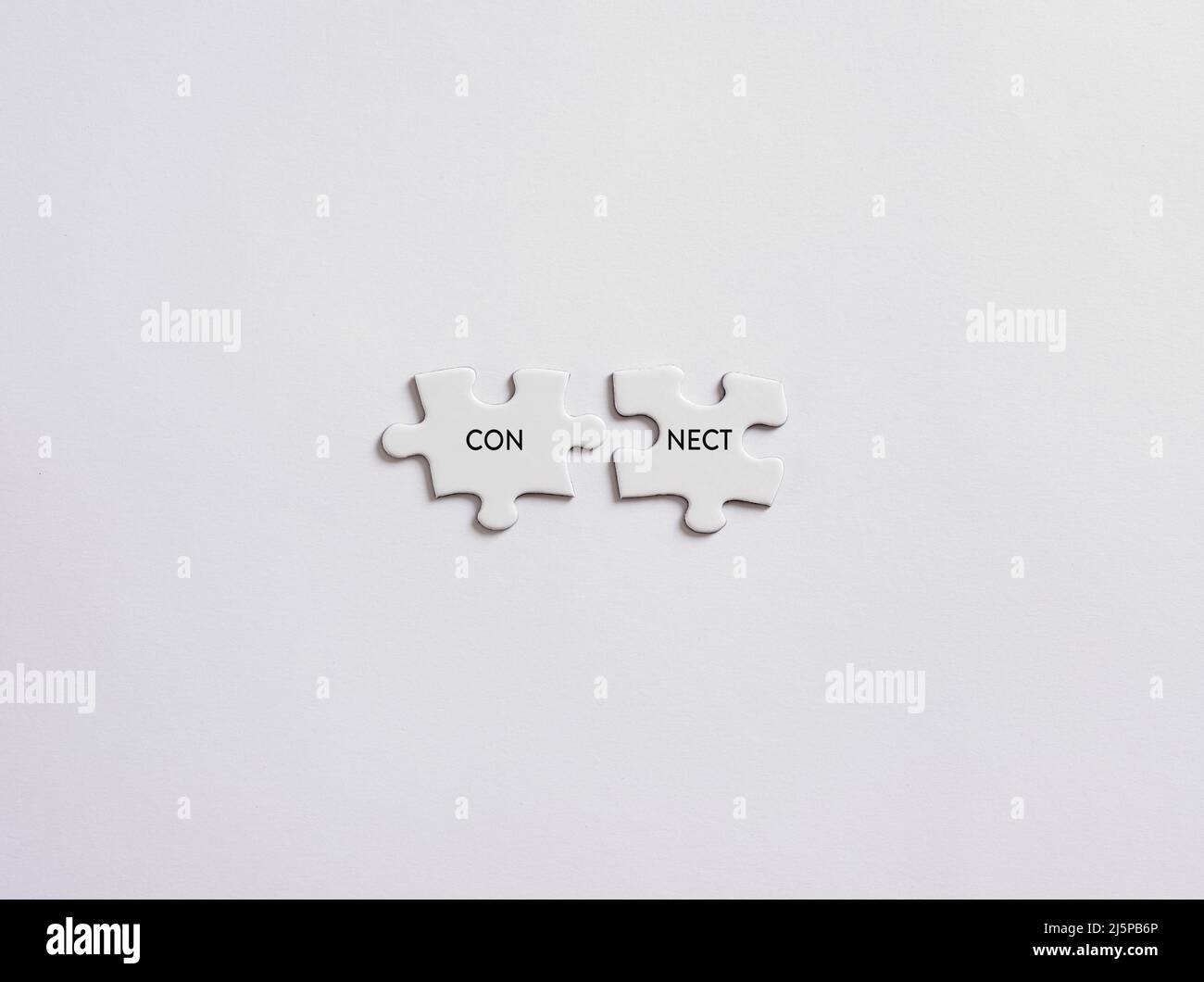 The word connect written on two puzzle pieces on white background ...