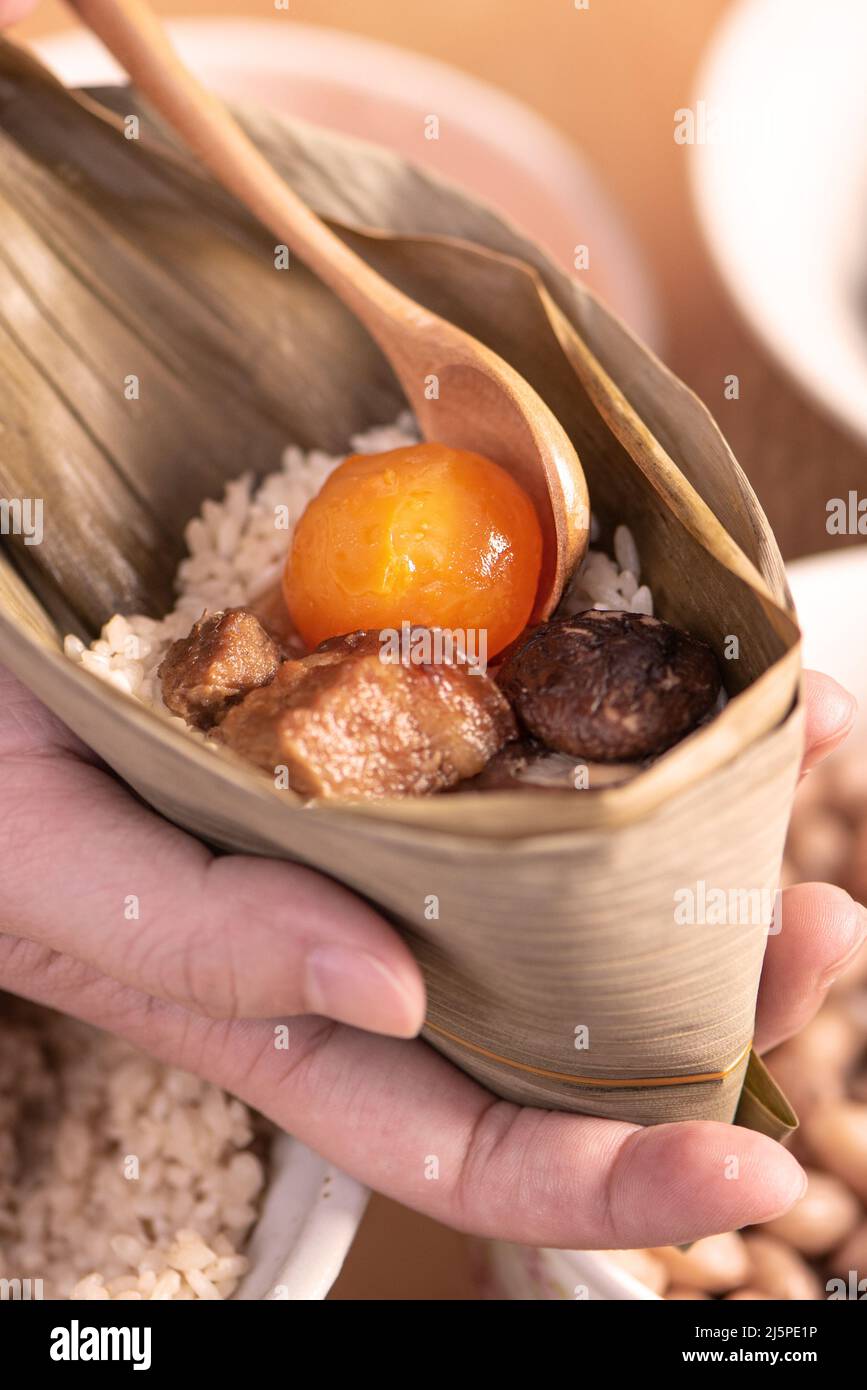 Making zongzi food preparing wrapping hi-res stock photography and ...