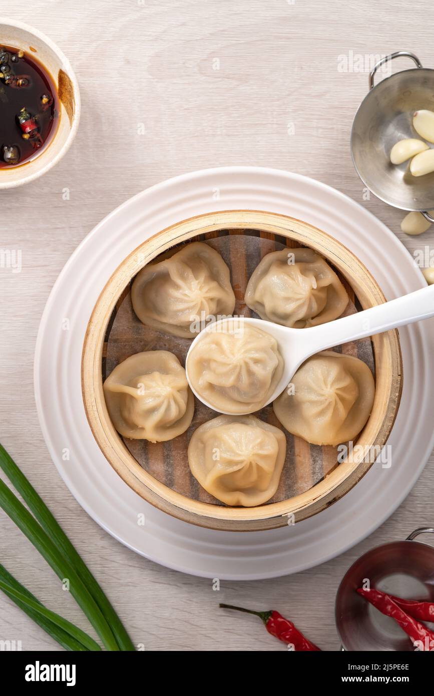 Eating steamed pork soup dumplings named Xiao long bao xiaolongbao in ...