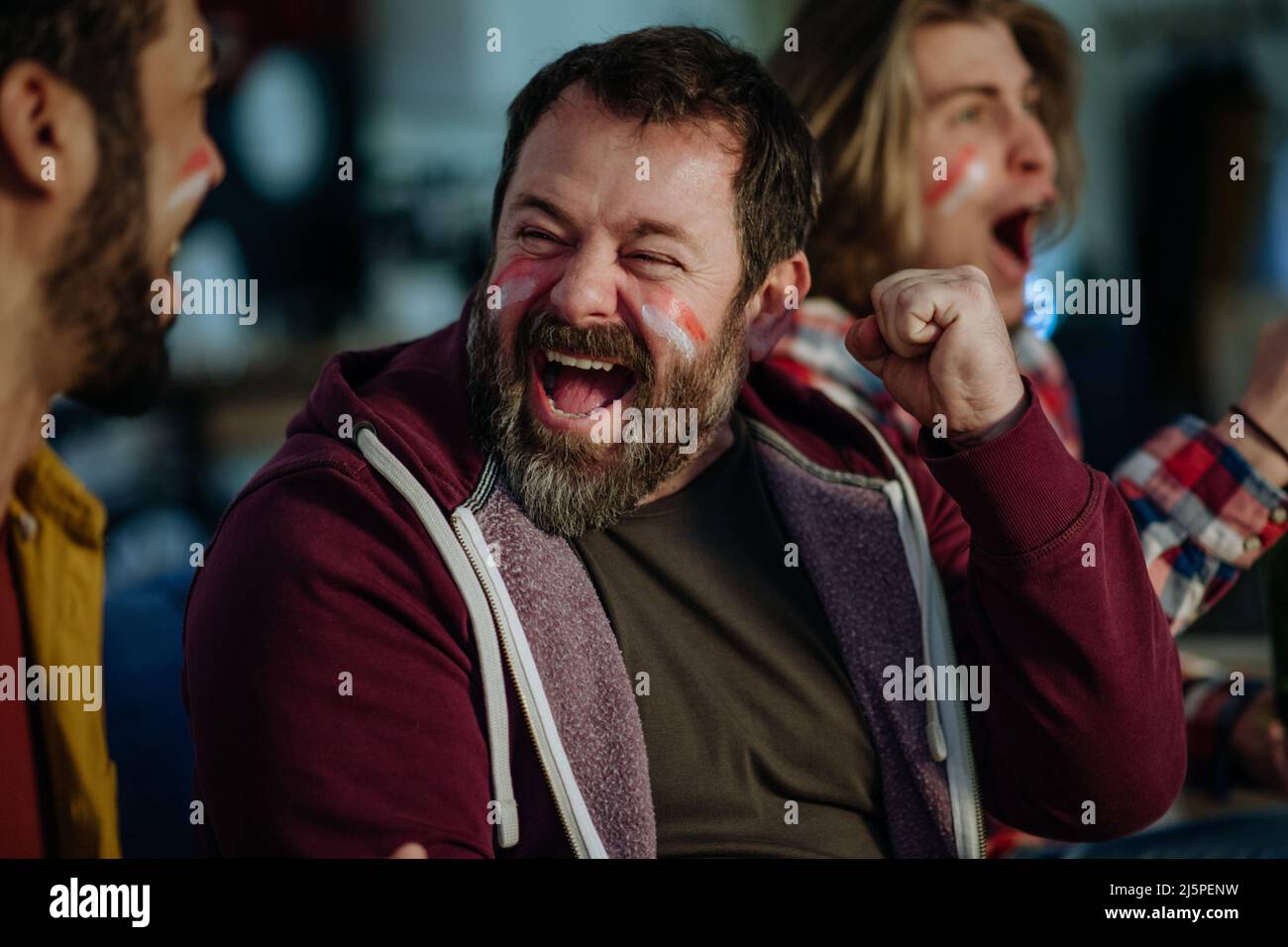 Happy Austrian football fans friends watching football at home and ...