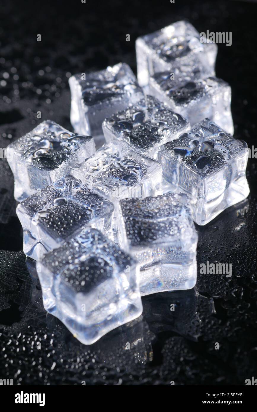 close up of many ice cubes on black background Stock Photo - Alamy