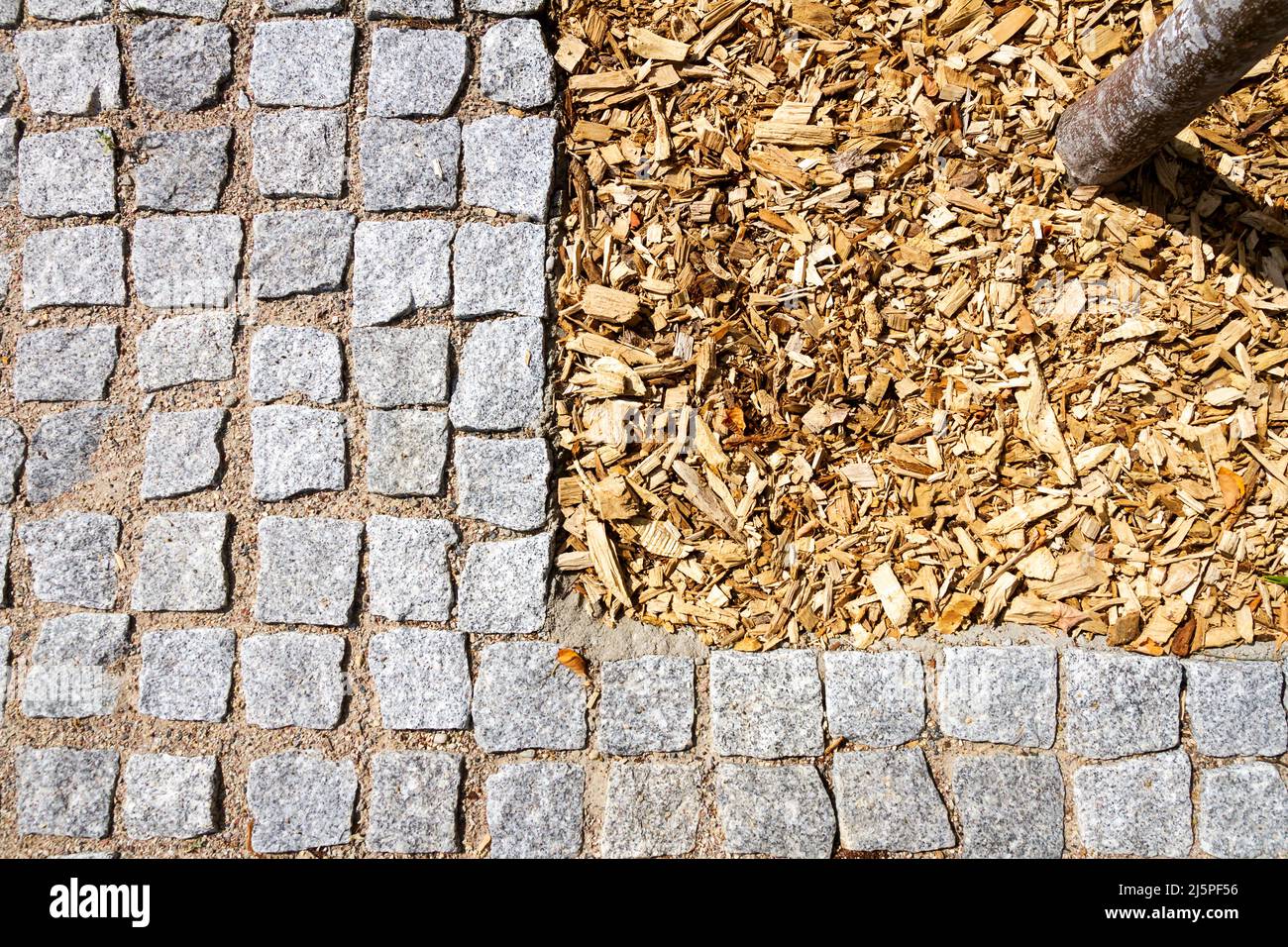 Gray granite blocks with wood chips and tree trunk Stock Photo - Alamy