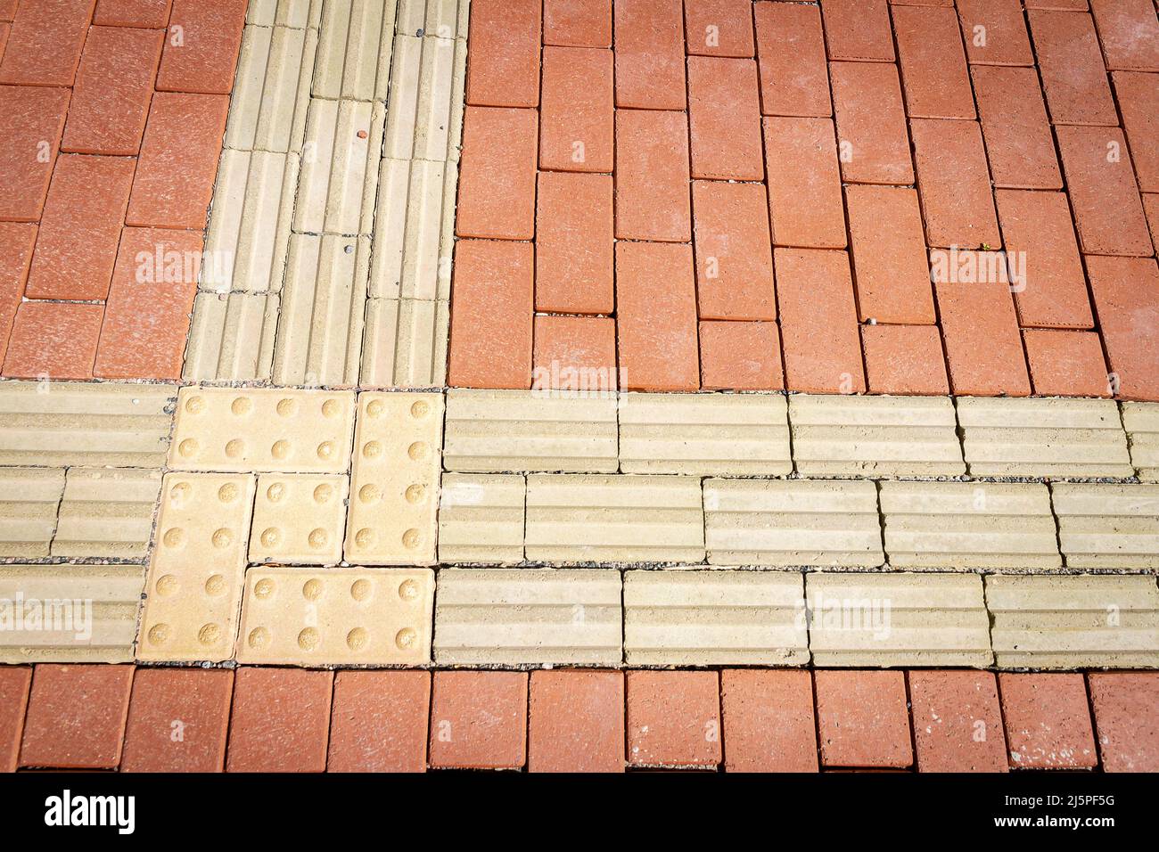 Textured walkway for blind people. Yellow tactile paving for the ...