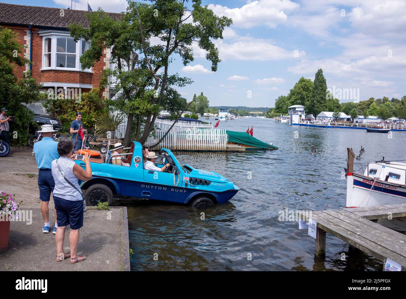 Spectators watch a Dutton Surf amphibious car driving into the River ...