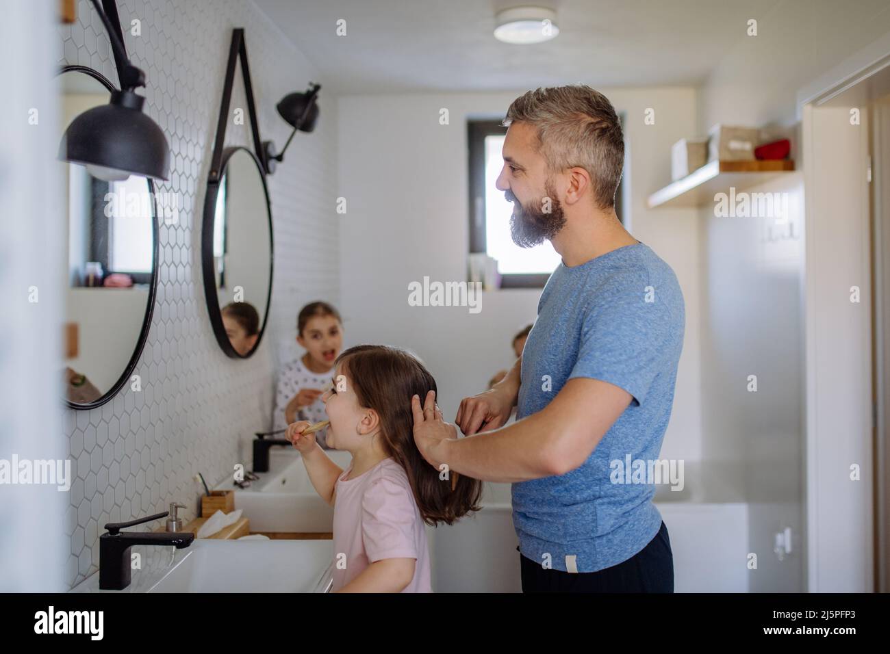 Father brushing his little daughter's hair in bathroom, morning routine concept Stock Photo - Alamy