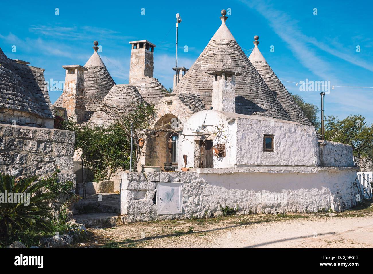 Group of beautiful Trulli or Trullo house, traditional Apulian dry ...