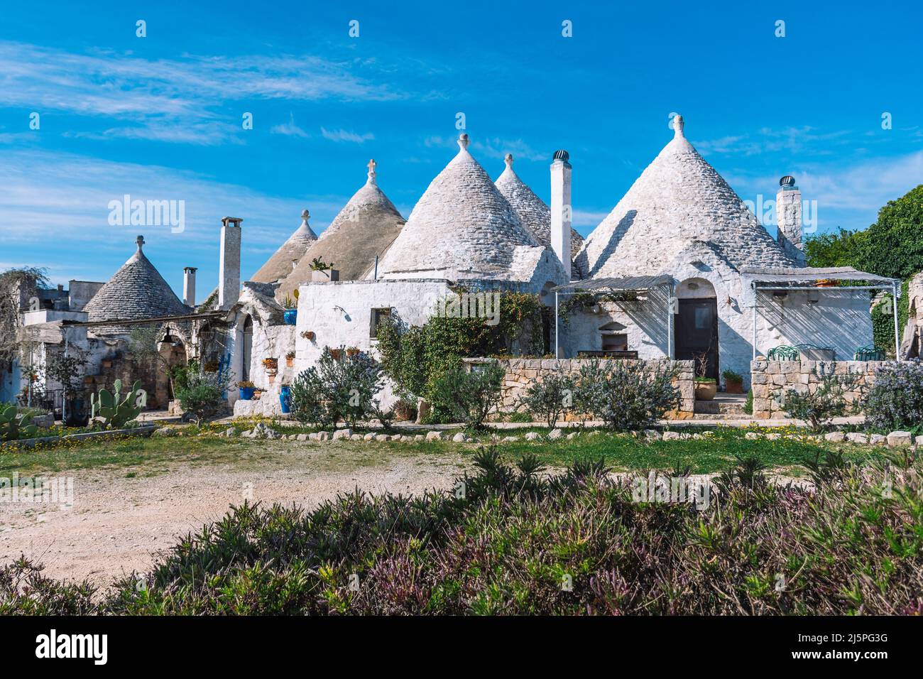 Group of beautiful Trulli or Trullo house, traditional Apulian dry ...