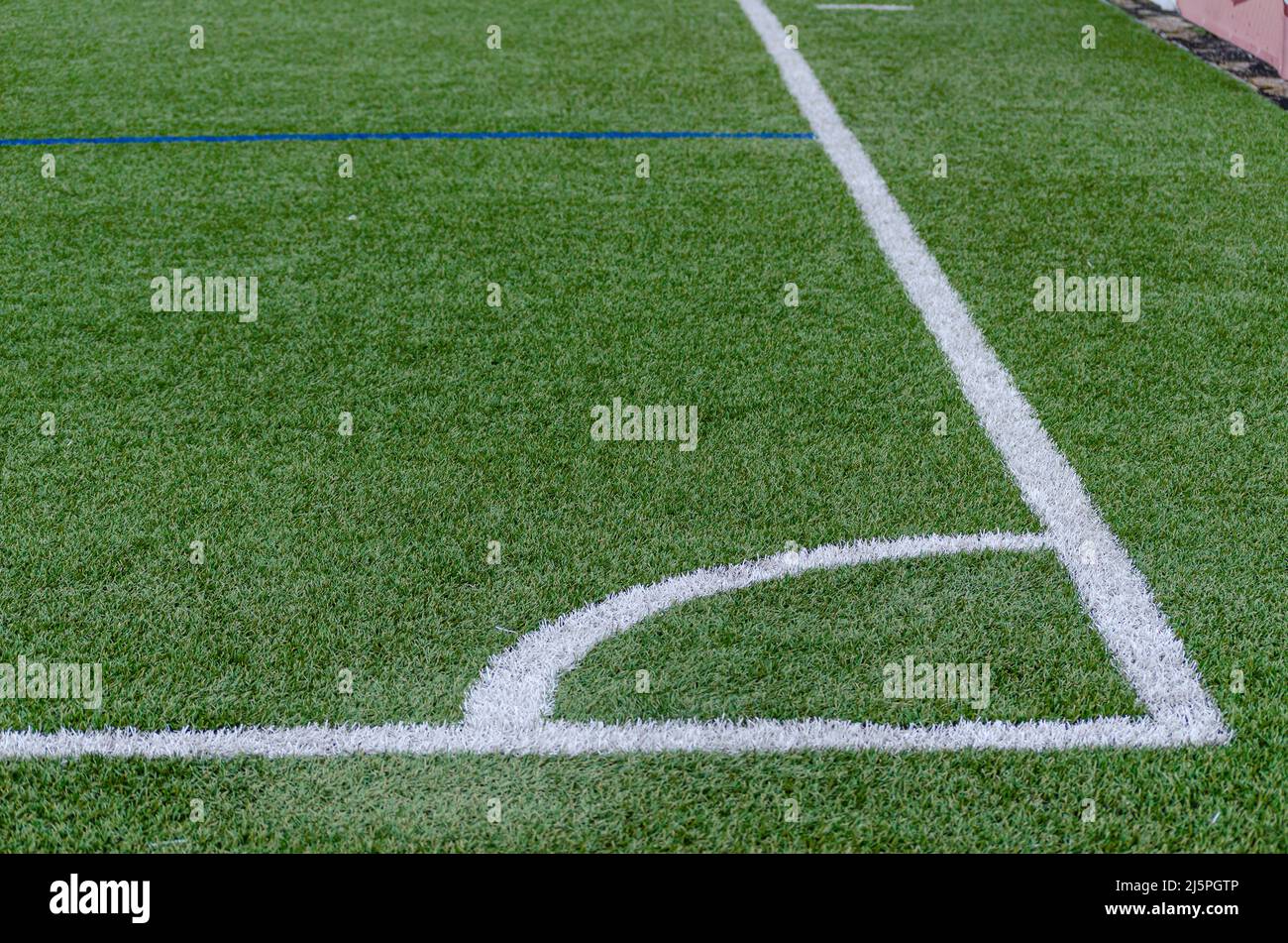 Corner line of a blue artificial turf football field Stock Photo - Alamy