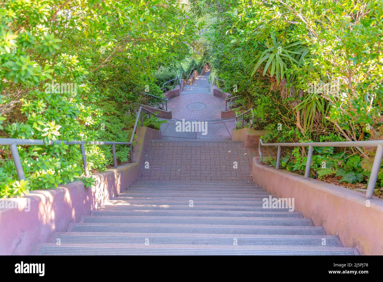 Outdoor staircase with concrete steps and metal handrails at San ...