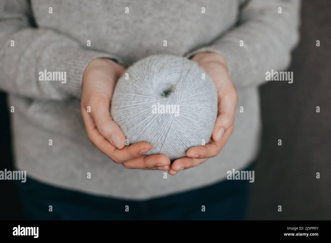 Female hands with yarn ball for knitting. Minimal concept. Selective ...