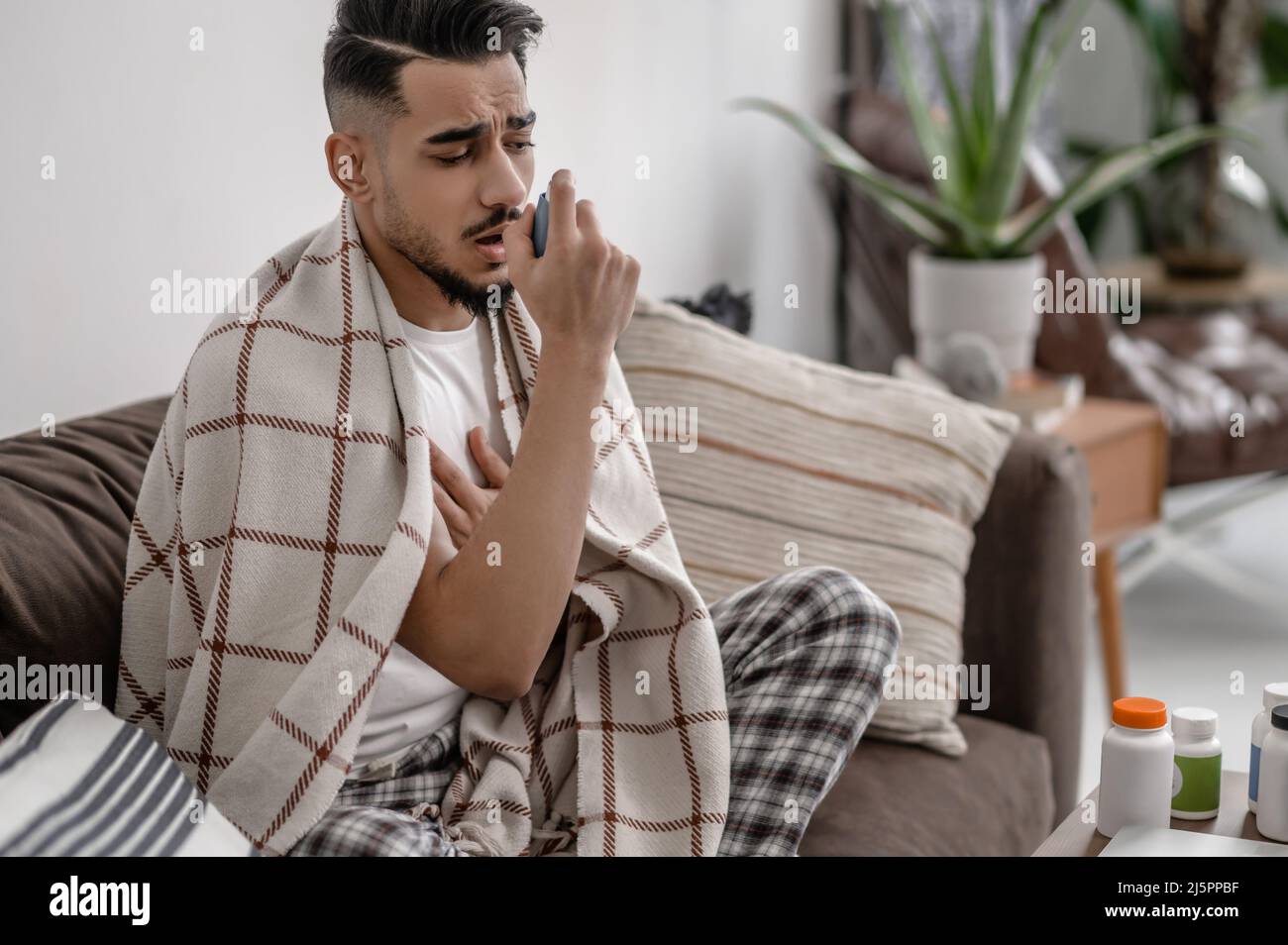 A dark-haired man having a running nose Stock Photo - Alamy