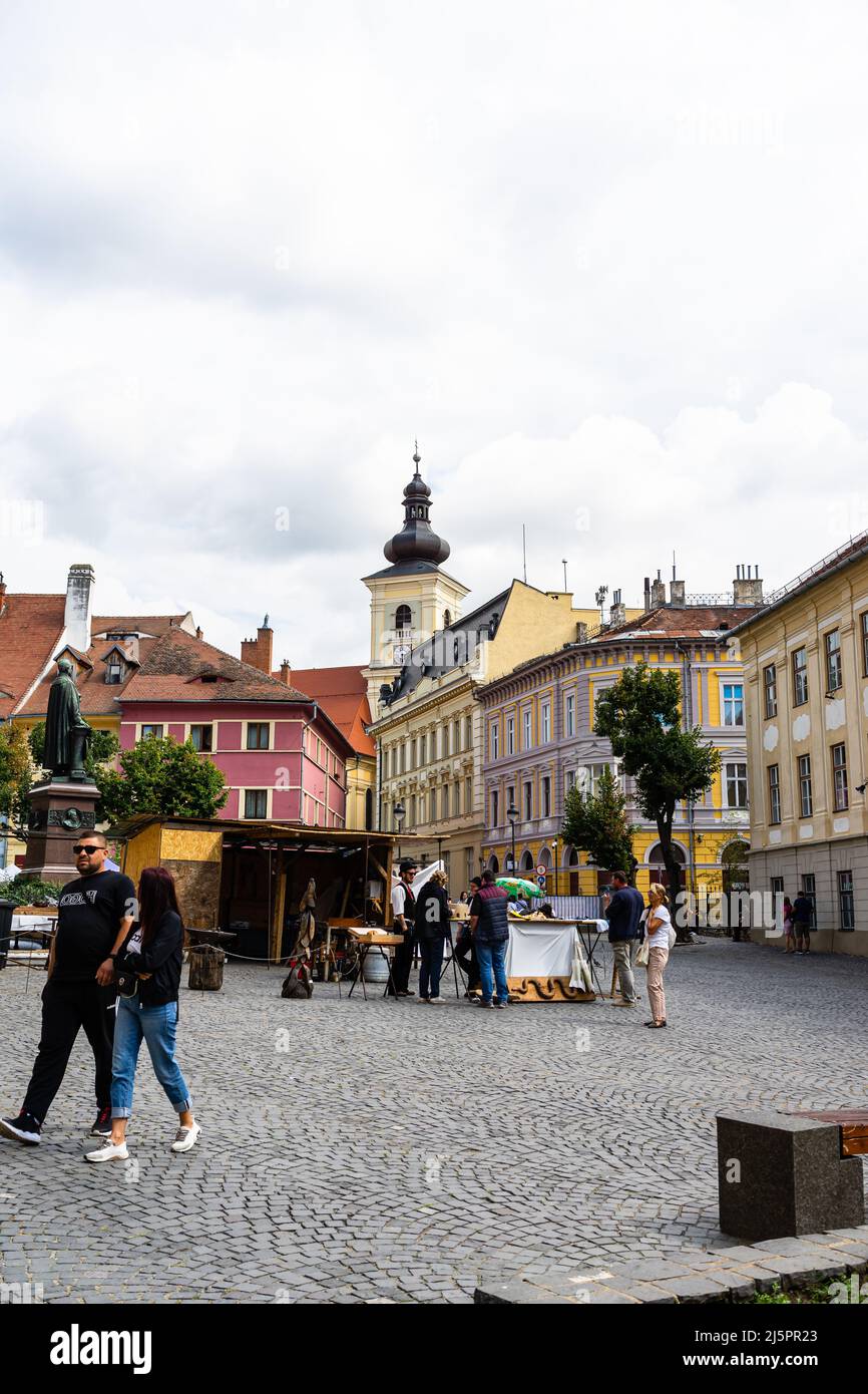 People and tourists wandering on the streets of old town Sibiu, Romania ...