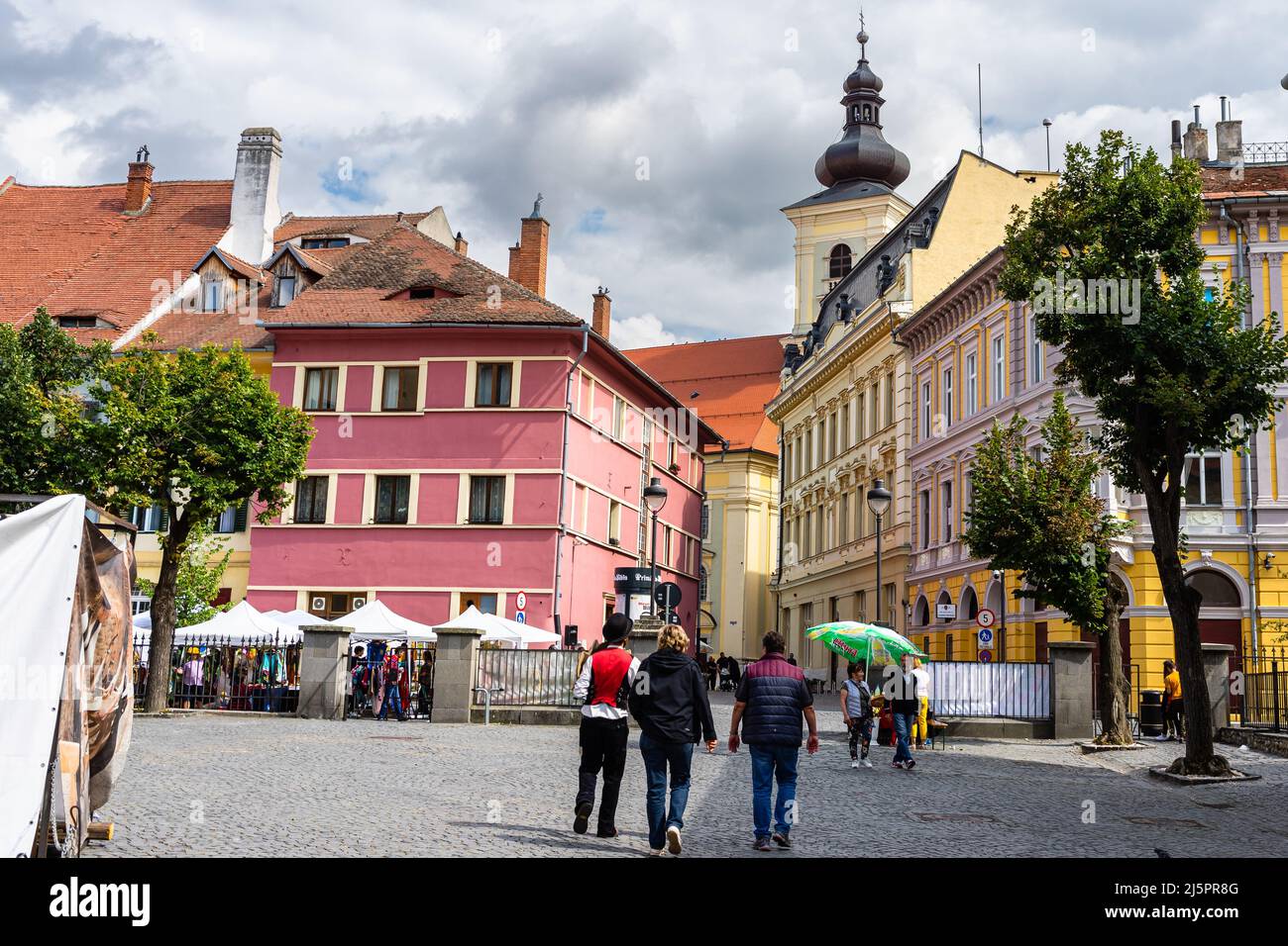 People and tourists wandering on the streets of old town Sibiu, Romania ...