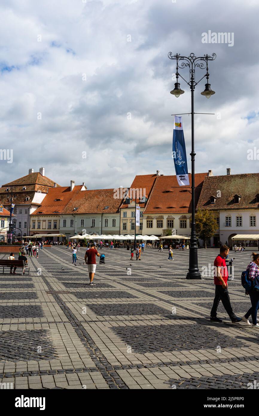 People and tourists wandering on the streets of old town Sibiu, Romania ...