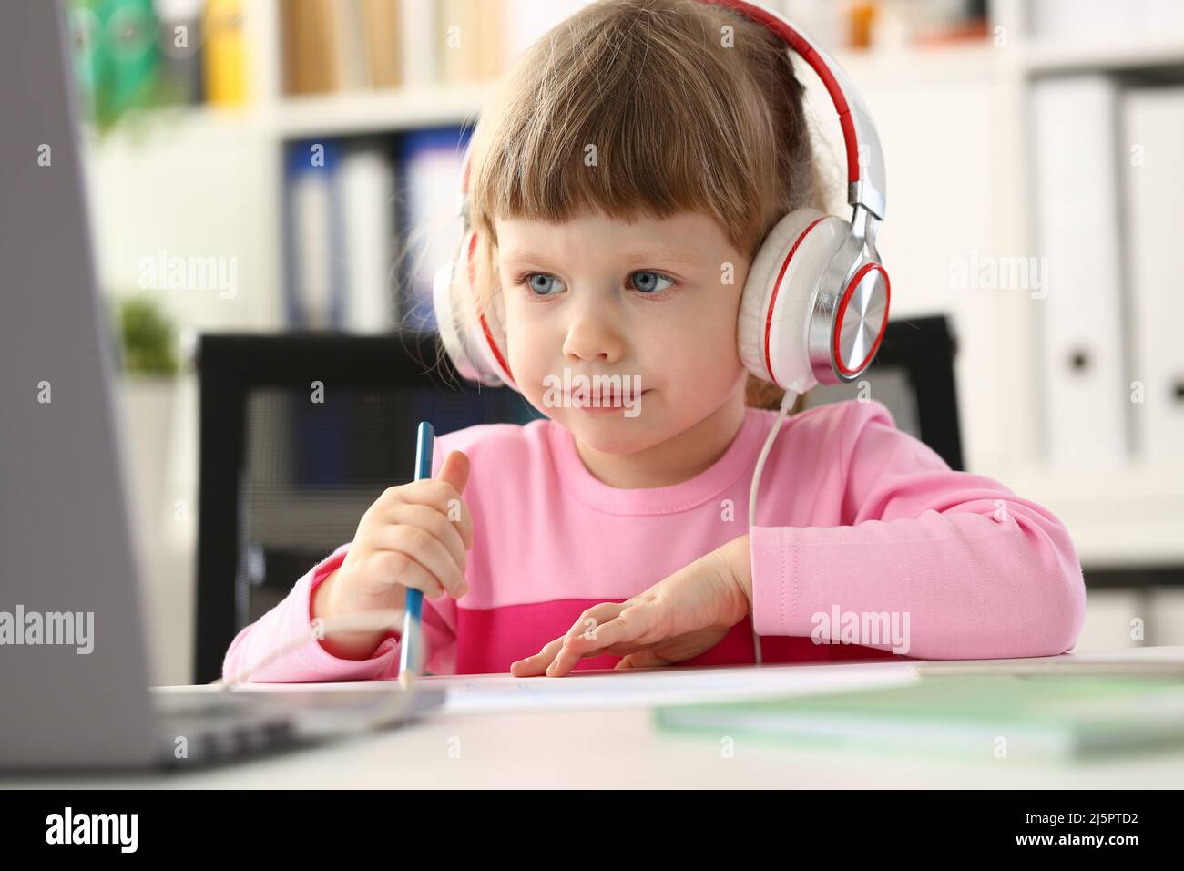 Little girl wearing headset, fun pastime or online education Stock ...