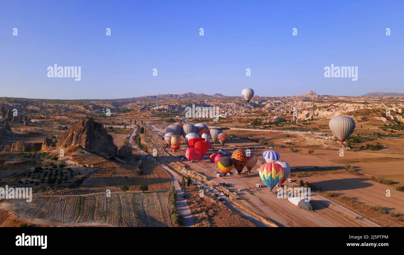 Aerial view of hot air balloons flying at sunrise in Cappadocia, Turkey ...
