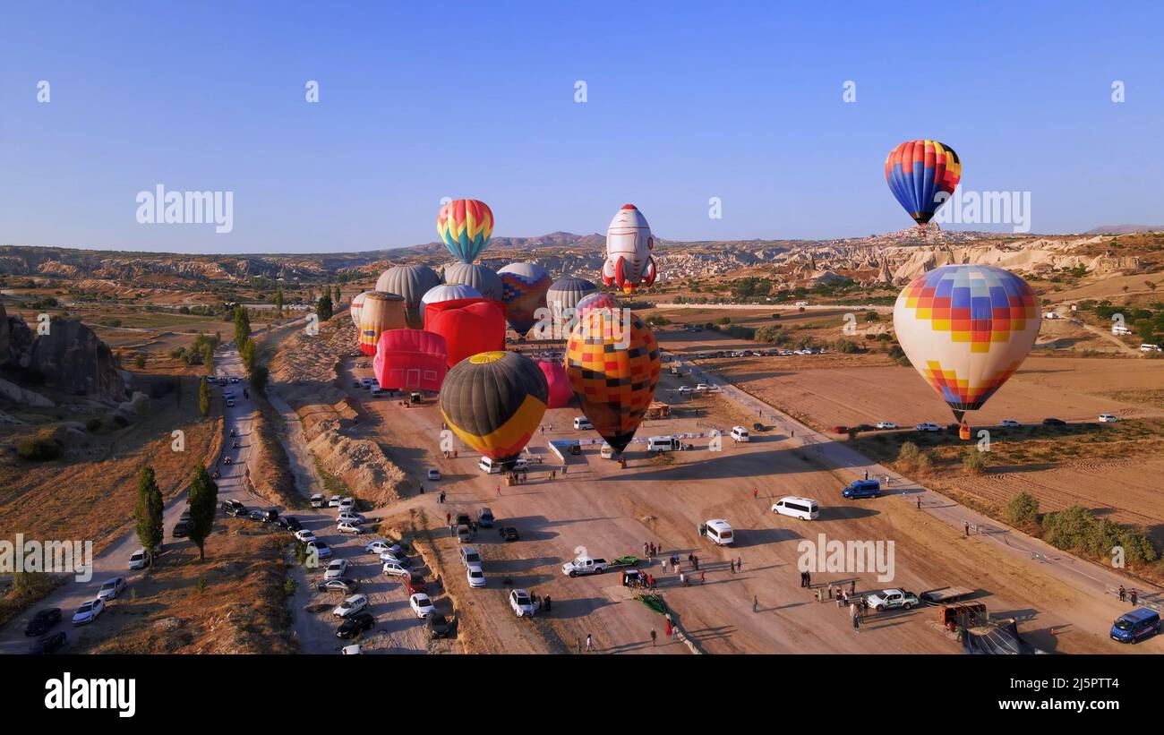 Aerial view of hot air balloons flying at sunrise in Cappadocia, Turkey ...