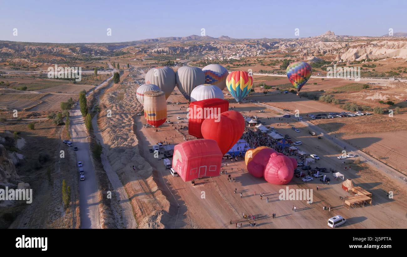 Aerial view of hot air balloons flying at sunrise in Cappadocia, Turkey ...