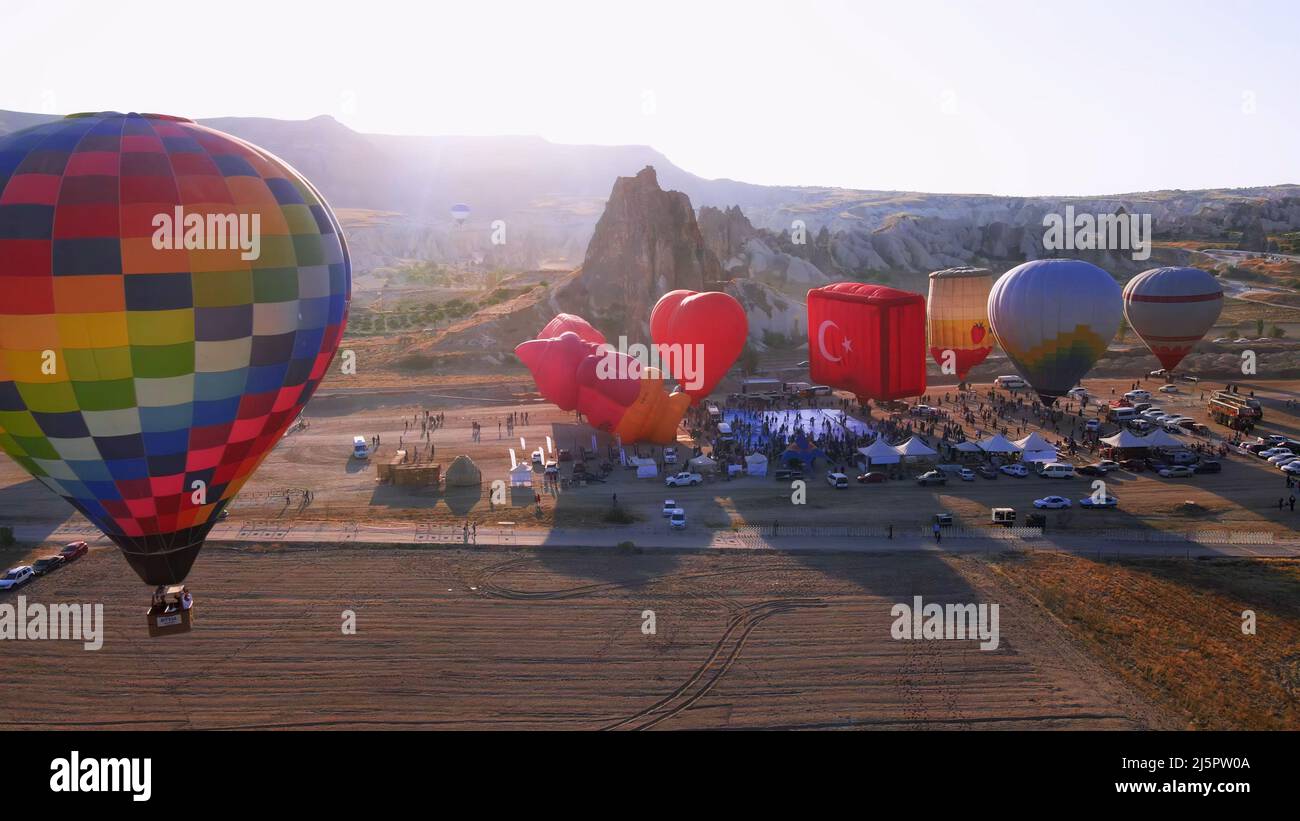 Aerial view of hot air balloons flying at sunrise in Cappadocia, Turkey ...